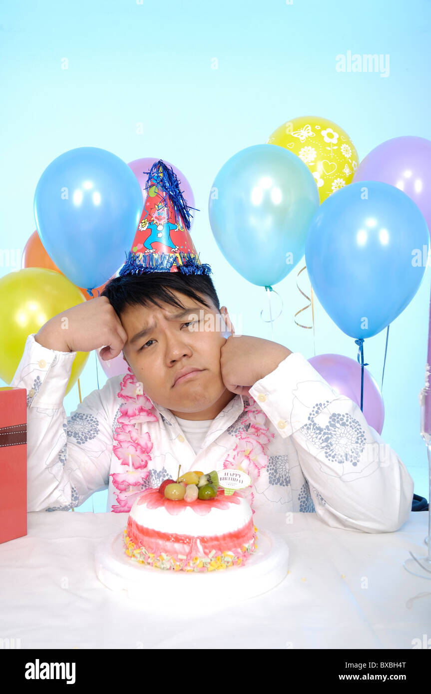 Man looking sad in a birthday party Stock Photo - Alamy
