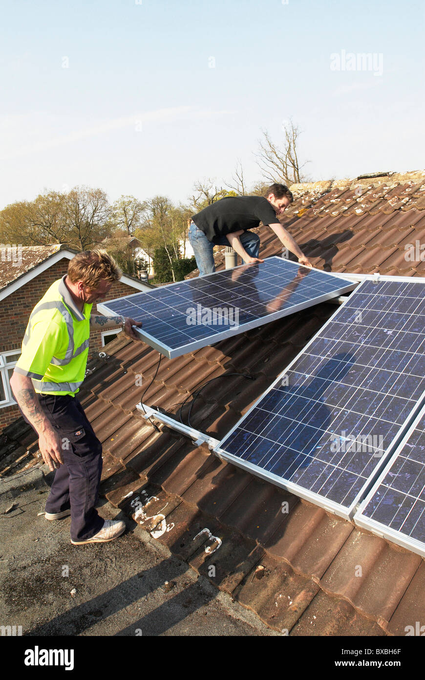 Fitting Photovoltaic panels onto the roof of a house North london UK ...
