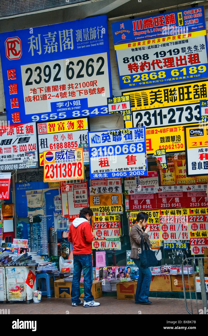 Two Asian people waiting in line to buy papers at newsstand Stock Photo ...