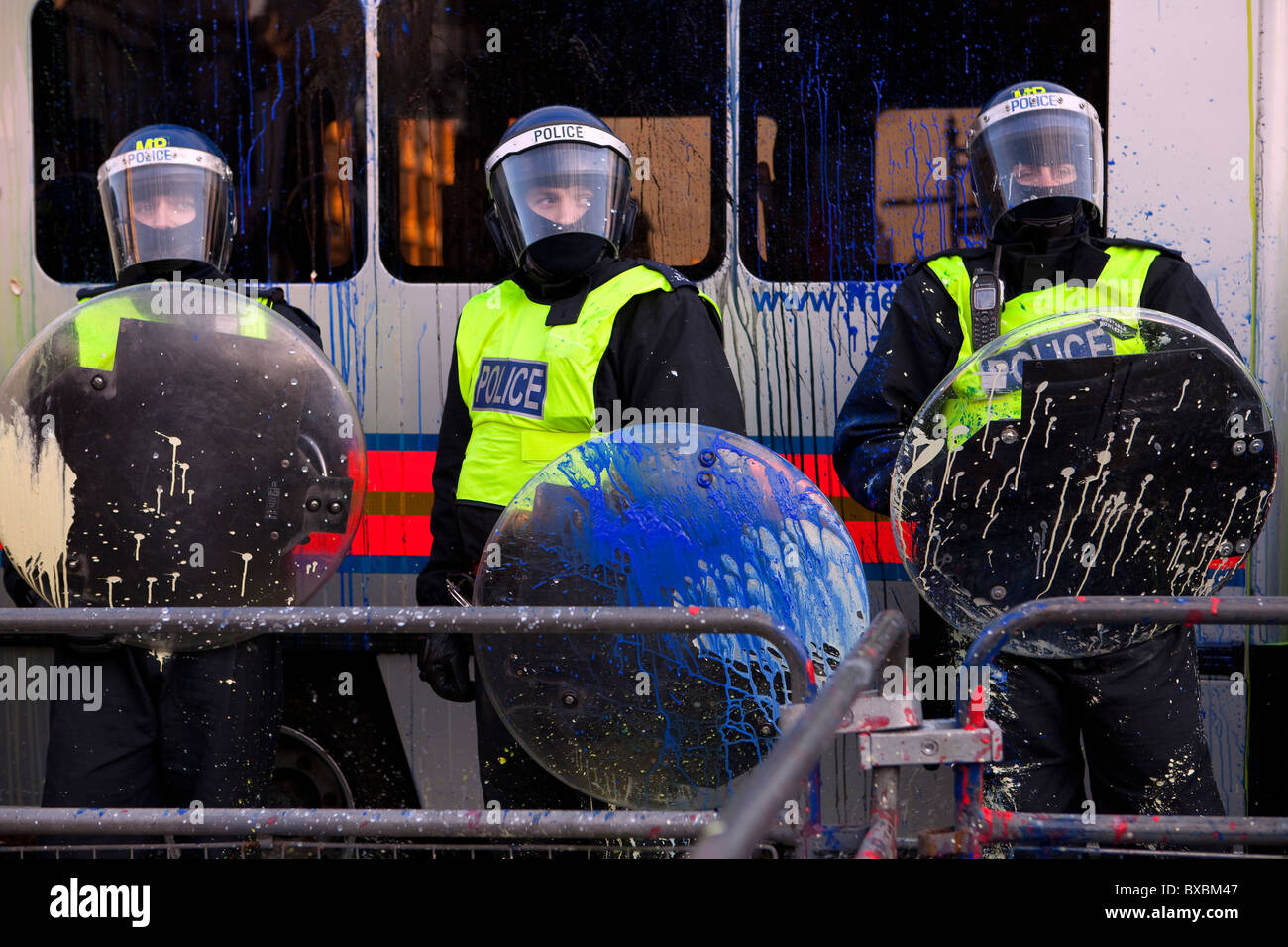 Riot police splattered with paint thrown by protesters during Tuition ...
