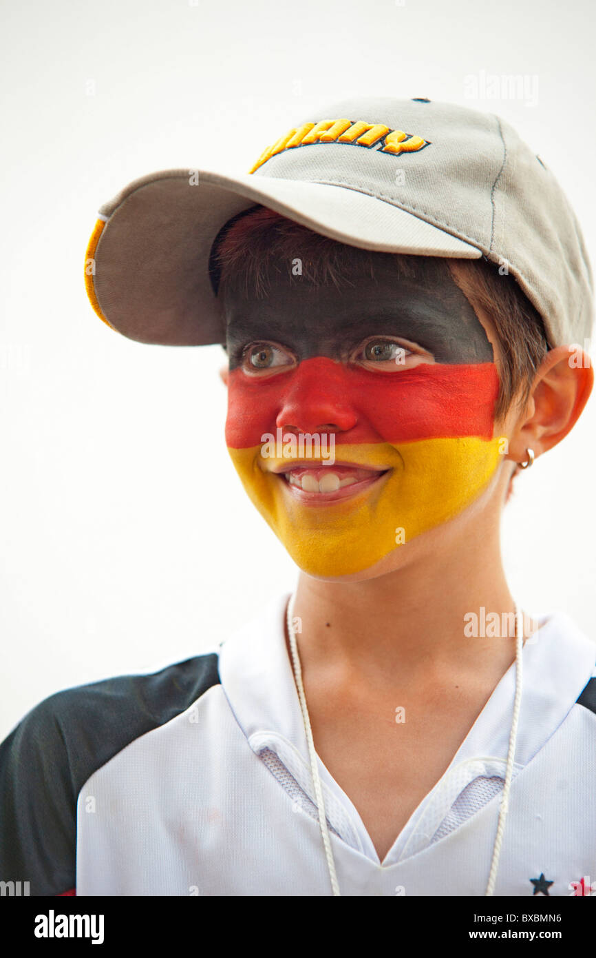 portrait of a young boy with his face painted in the German National ...