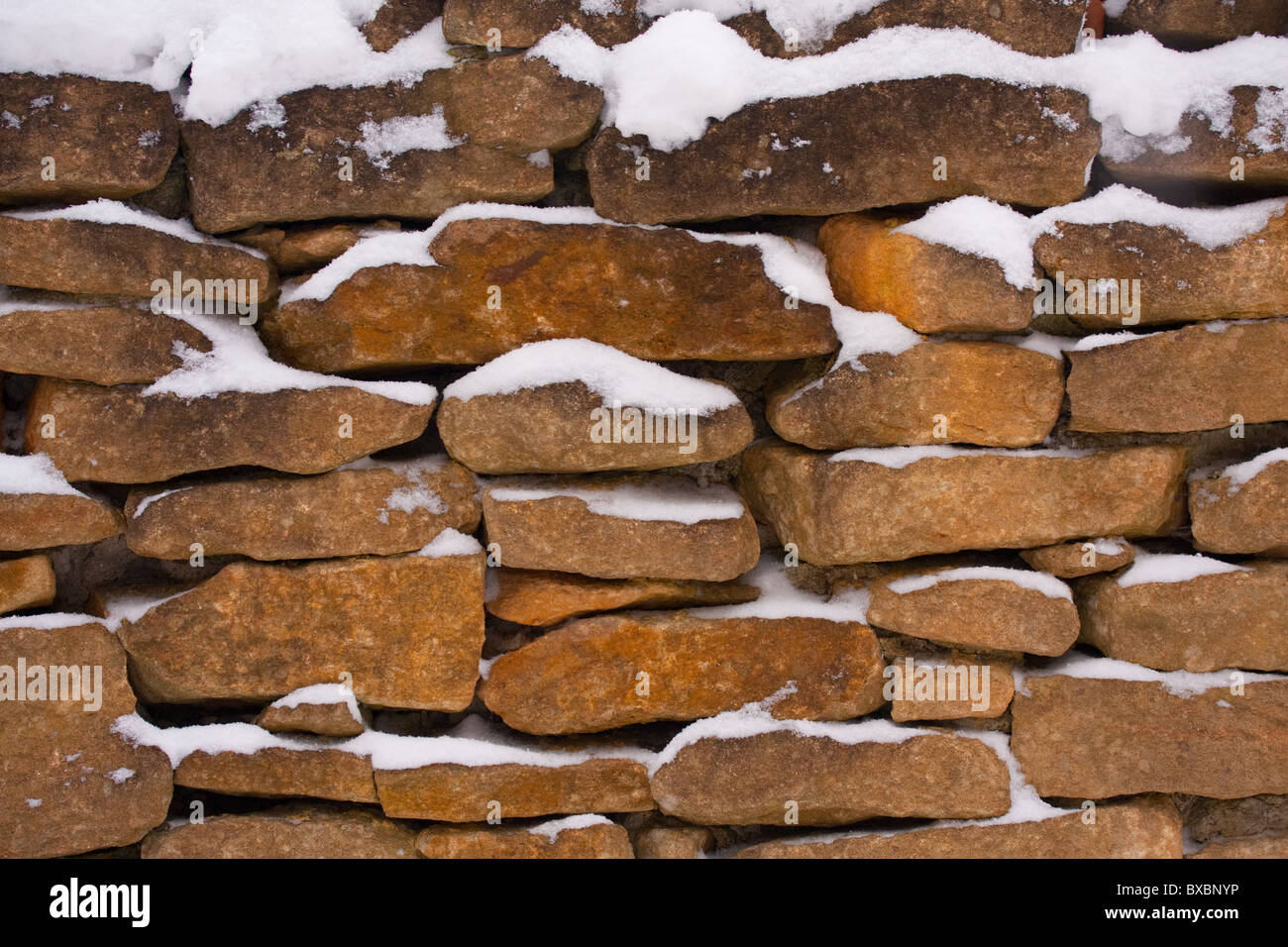 Stone wall with snow Stock Photo - Alamy