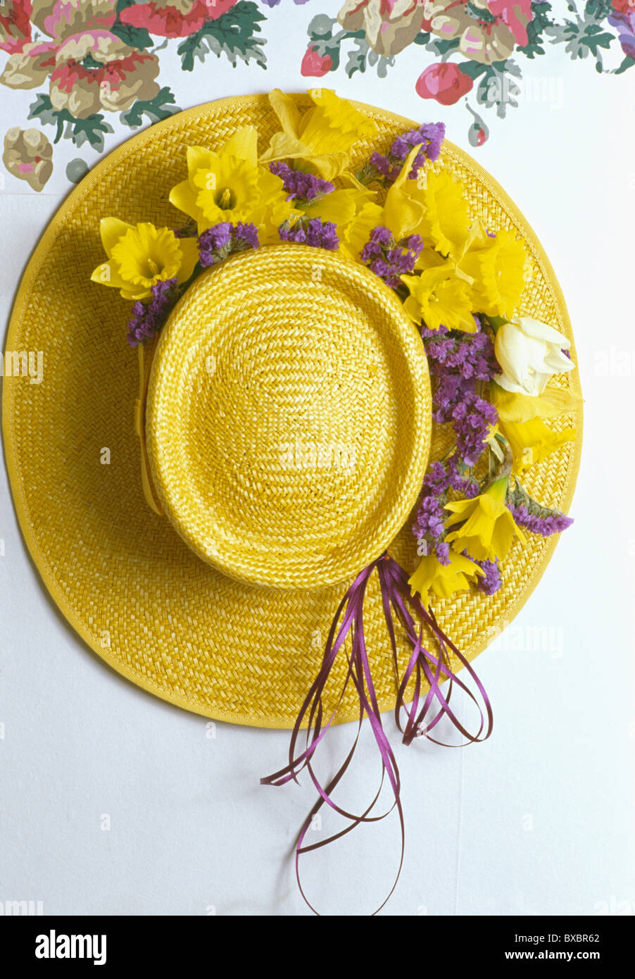 Close-up of yellow straw hat decorated for Easter with yellow daffodils ...