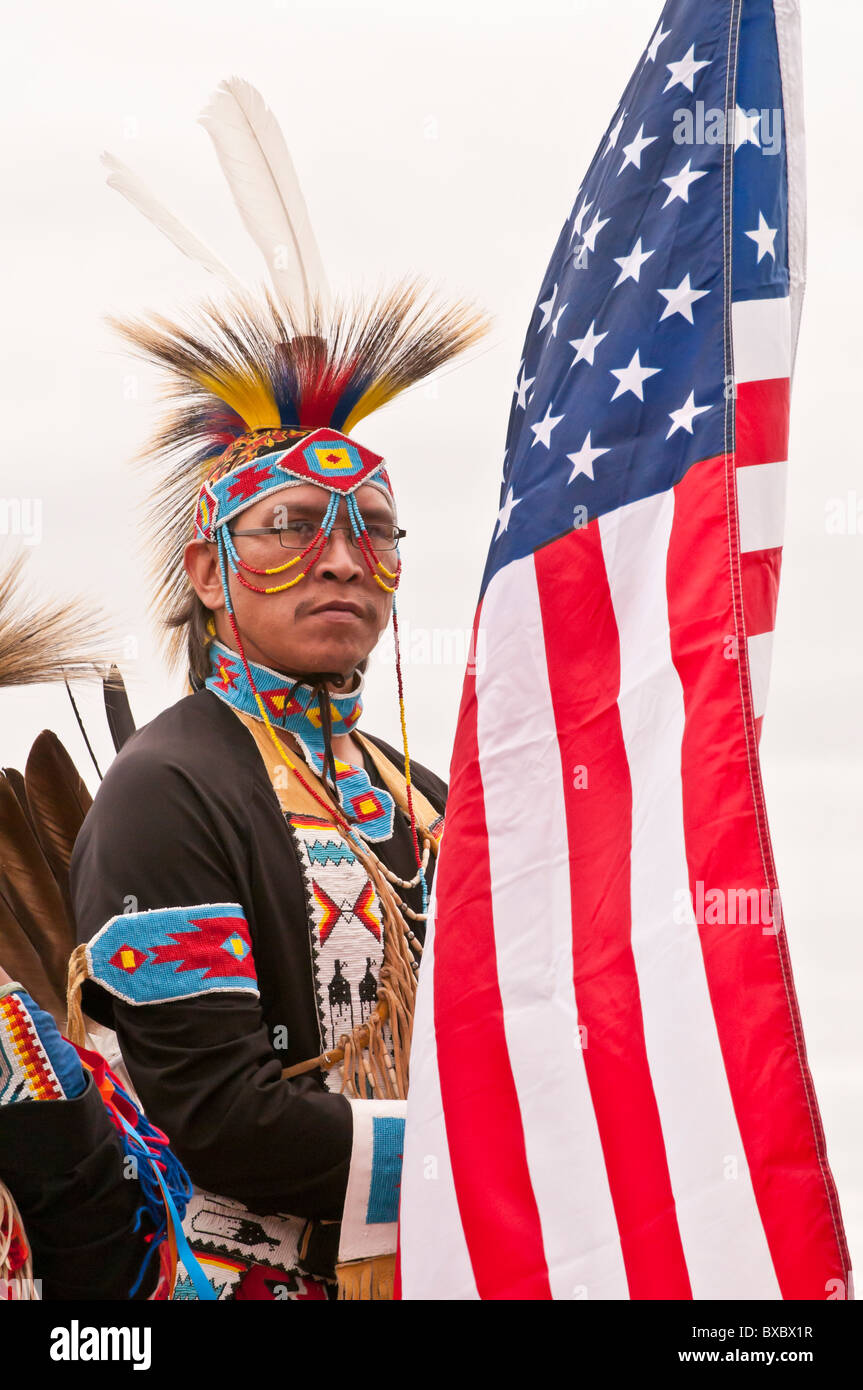 Adult male native warrior (First Nations), with American flag, at pow ...