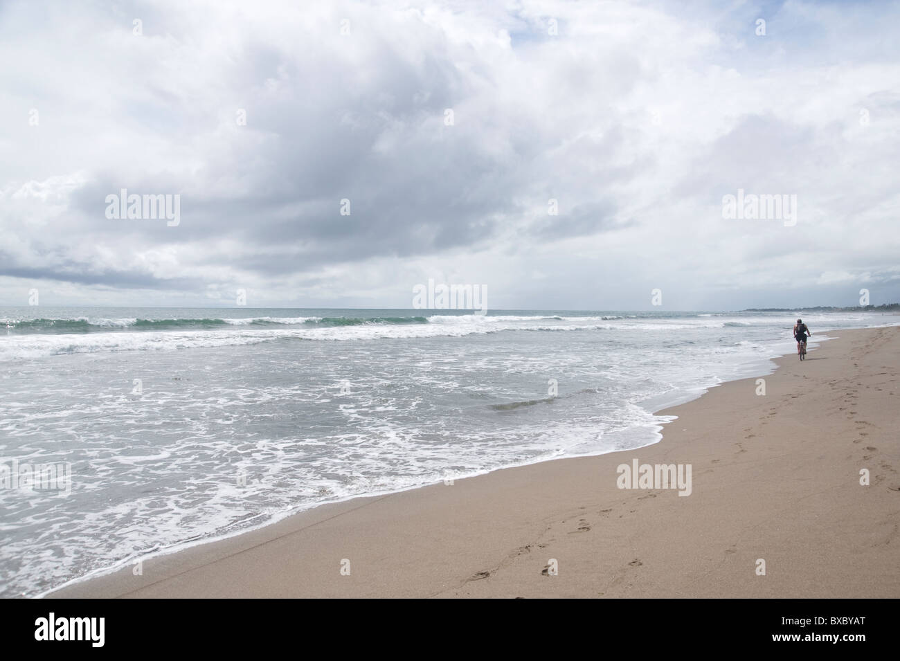 Person walking along beach in Bali Stock Photo - Alamy