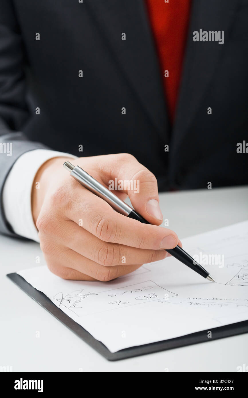 Male hand drawing a scheme of business process on the paper Stock Photo ...