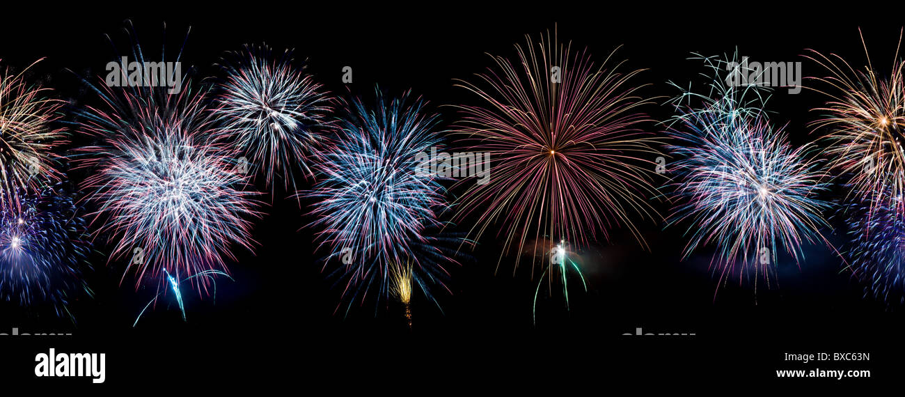 repeatable horizontal border of fireworks blasts on black sky - long ...
