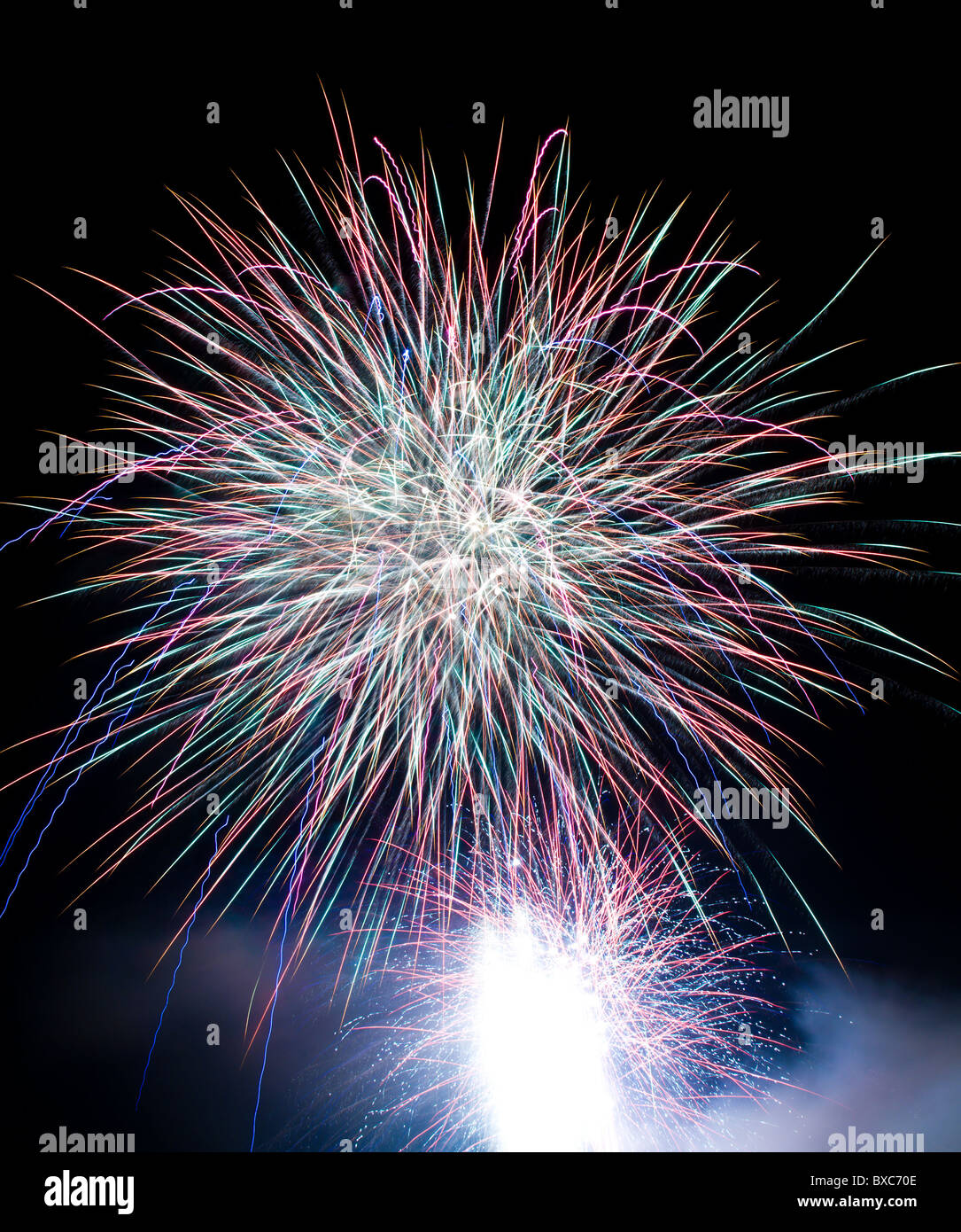 few fireworks blasts on black sky - long exposure Stock Photo - Alamy