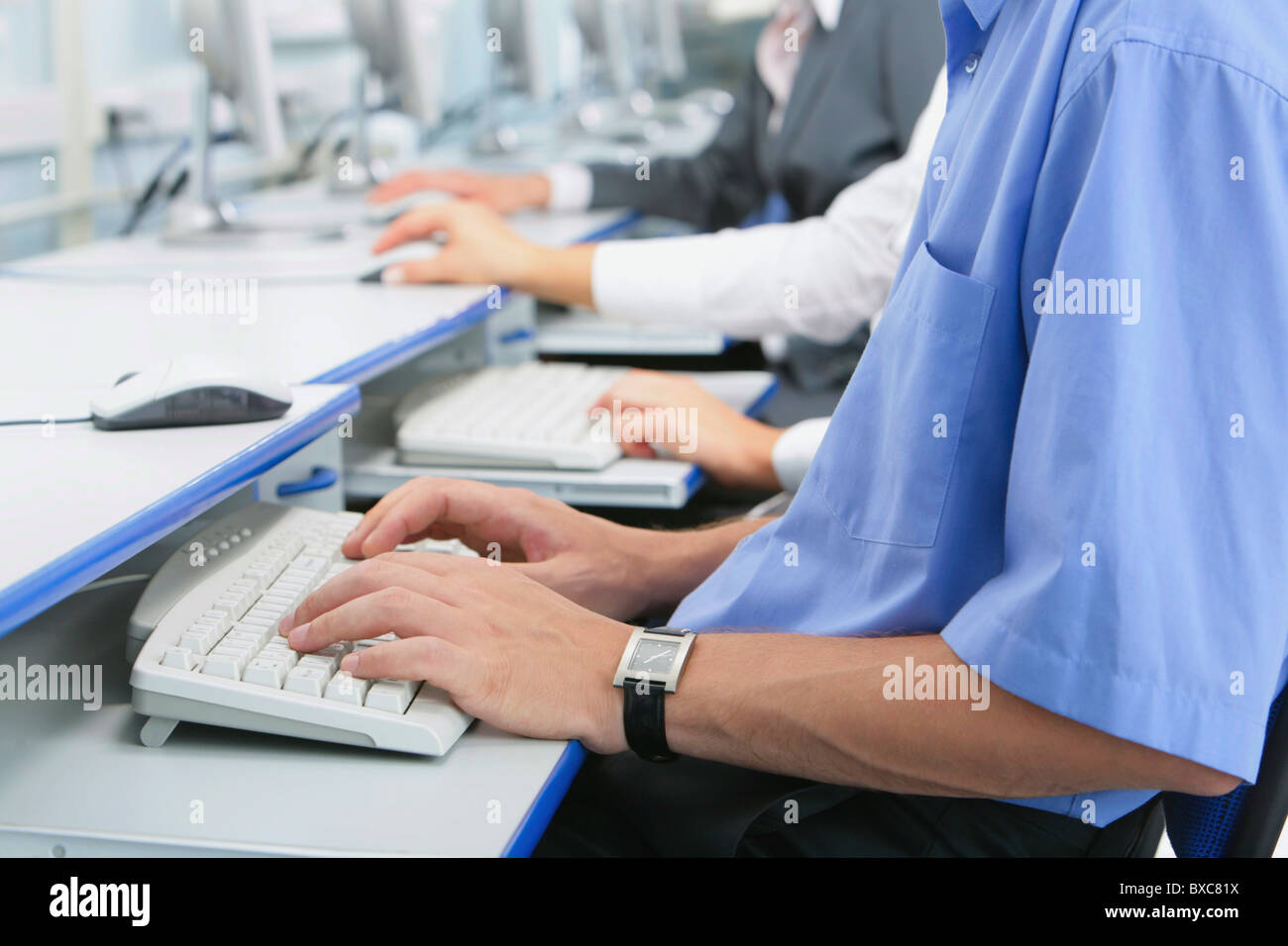 Human hands typing on the keyboard in the computer room Stock Photo - Alamy