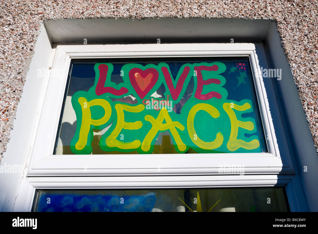 LOVE AND PEACE painted white UPVC double glazed window Stock Photo - Alamy