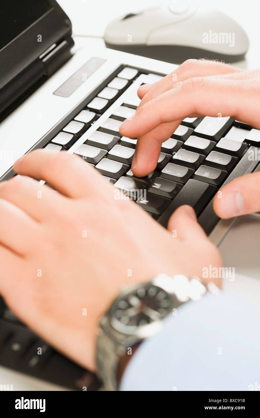 Human hands typing on the laptop Stock Photo - Alamy