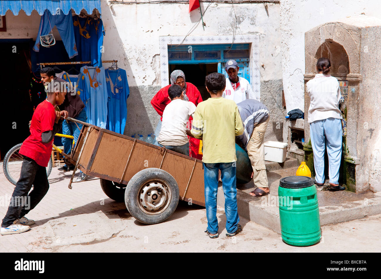 A group of people loading containers of water in the Medina of ...