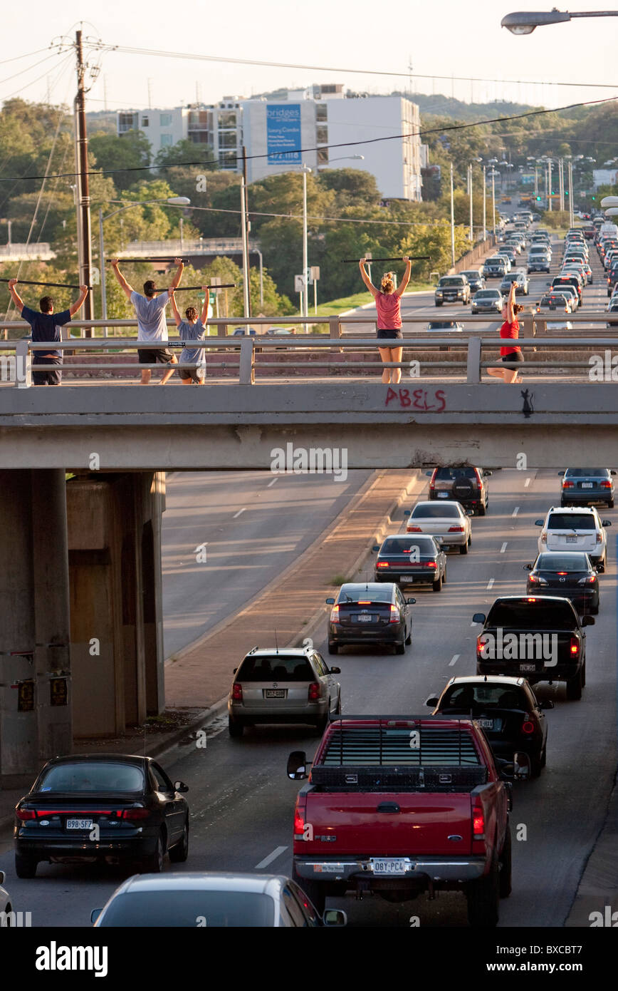 Members of an exercise class from a downtown gym work out as afternoon ...