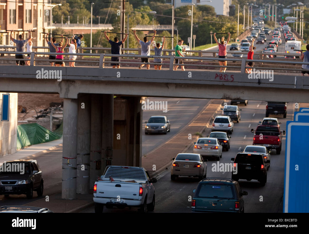 Members of an exercise class from a downtown gym work out as afternoon ...