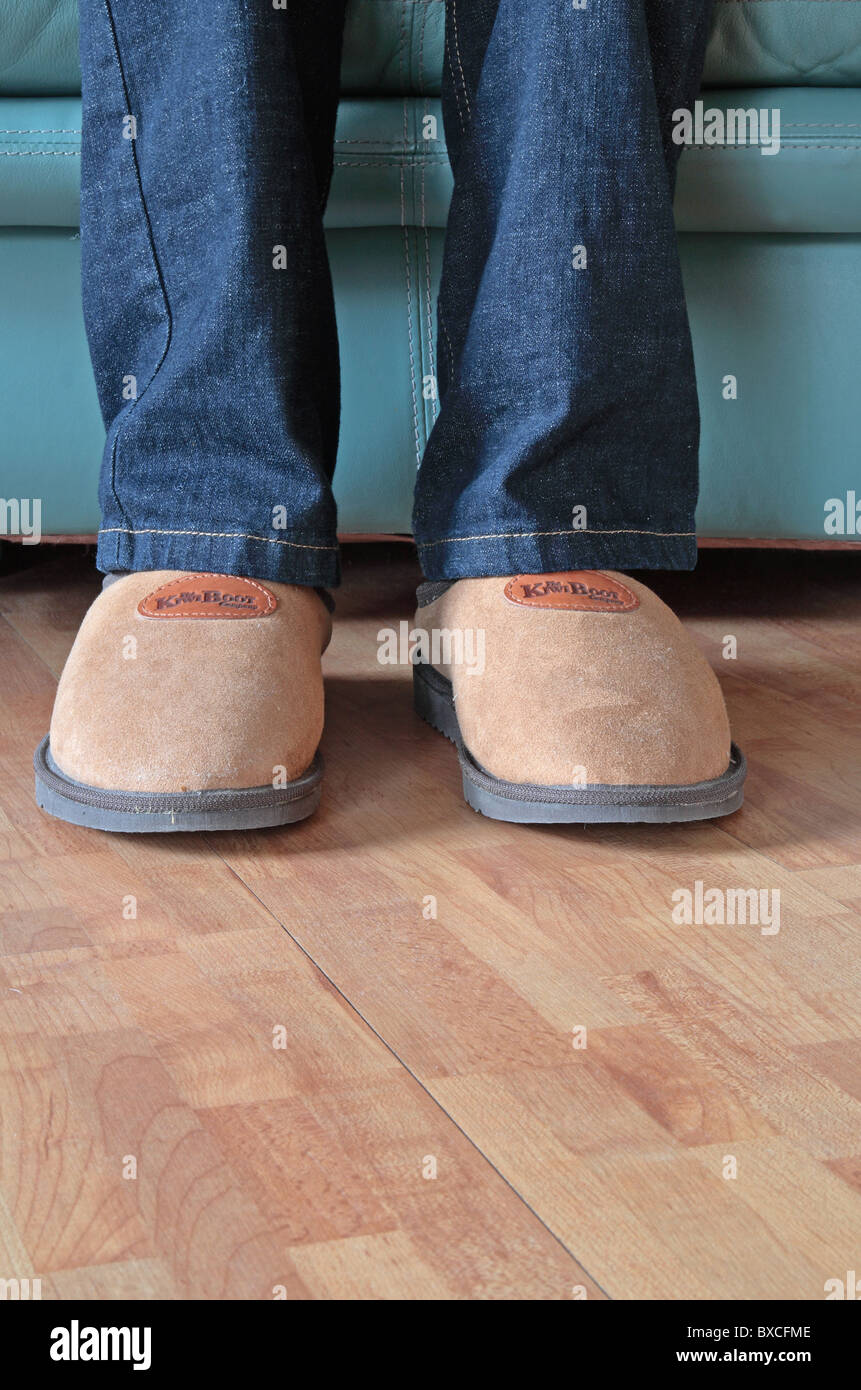 Man Wearing Sheepskin Comfy Slippers Whilst Sitting Down in a Leather ...