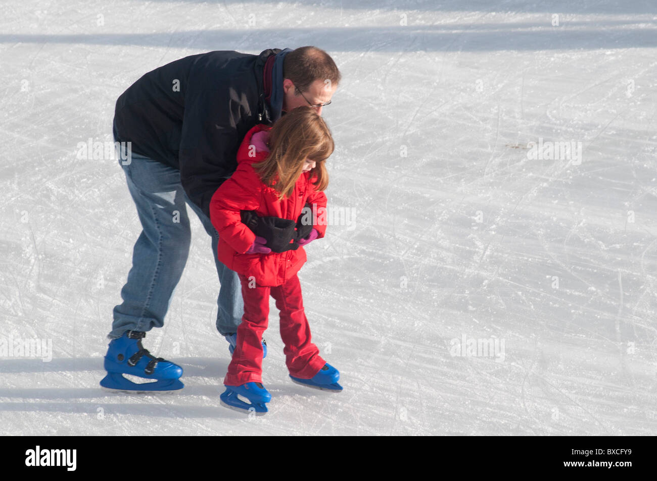 Family enjoying the Outdoor Temporary Christmas Ice Rink set up ...
