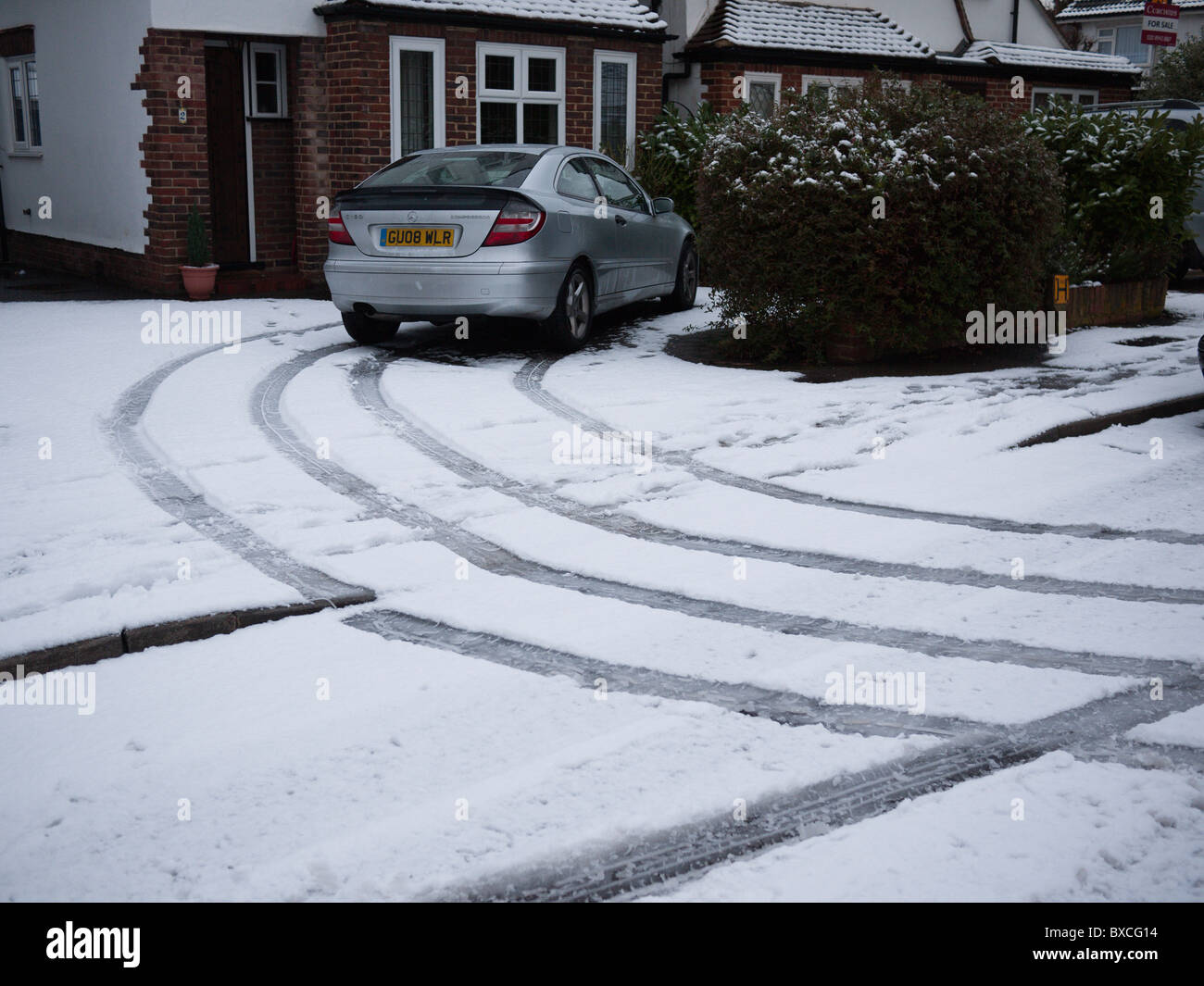 tyre tracks in the ice after an owner has parked his car Stock Photo ...