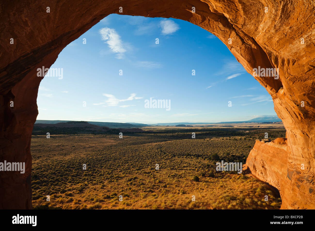 A view at sunrise looking out from Looking Glass Arch in Southeast Utah ...