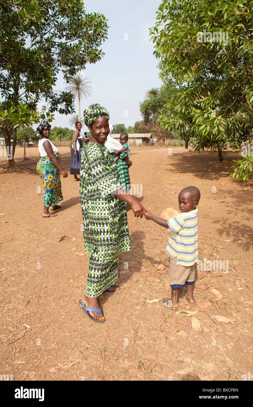 A woman and her young grandson walk the streets of Port Loko, Sierra ...