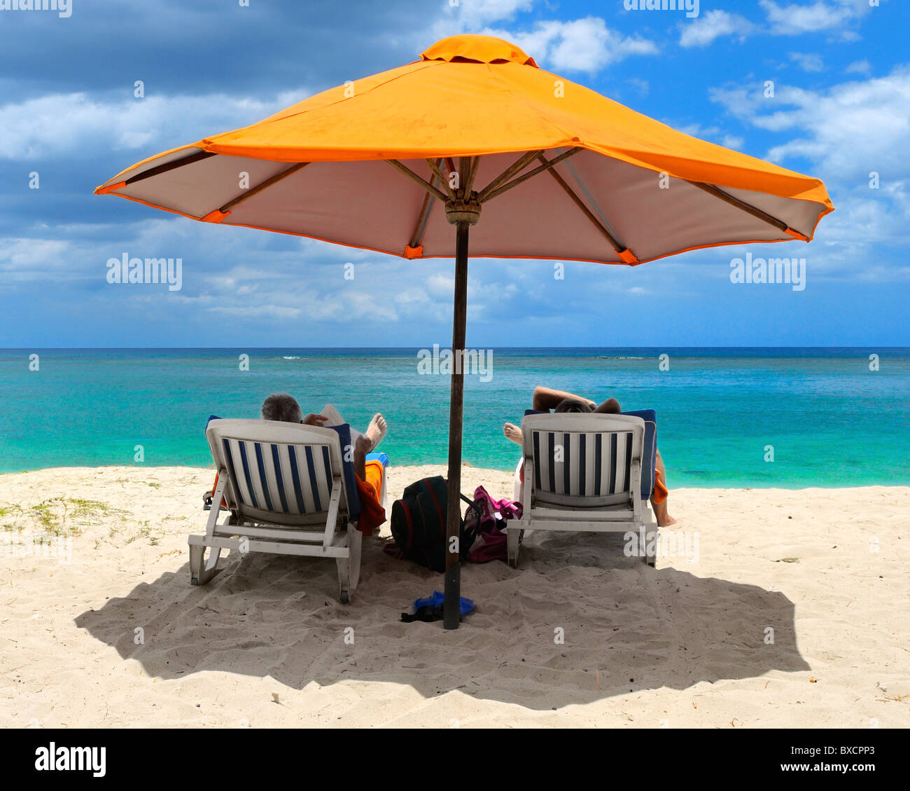 Tourists enjoy the afternoon at the long white sand beach in Flic en ...