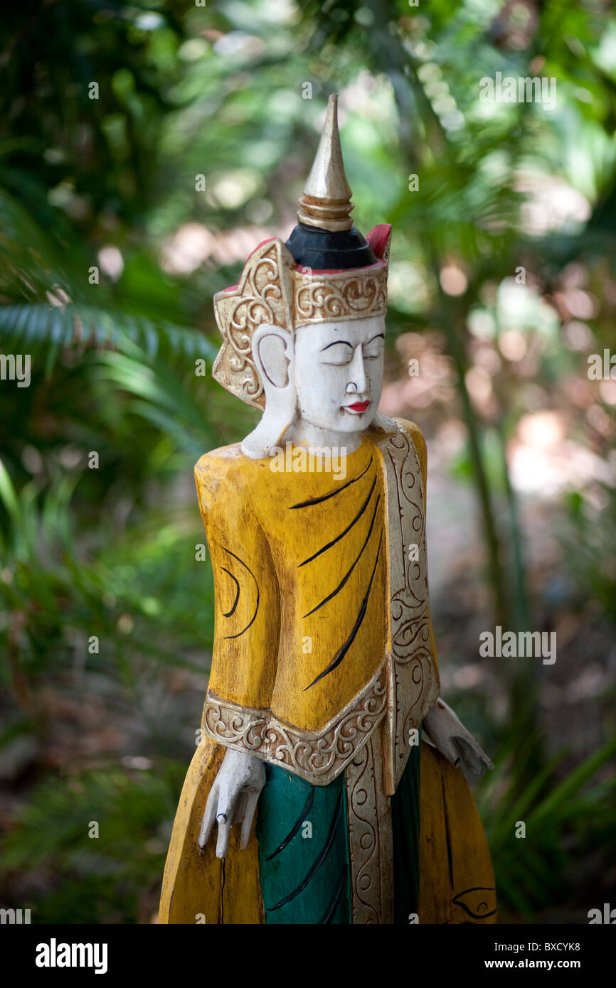 Wooden asian statue with ornate headpiece and large earlobes Stock ...