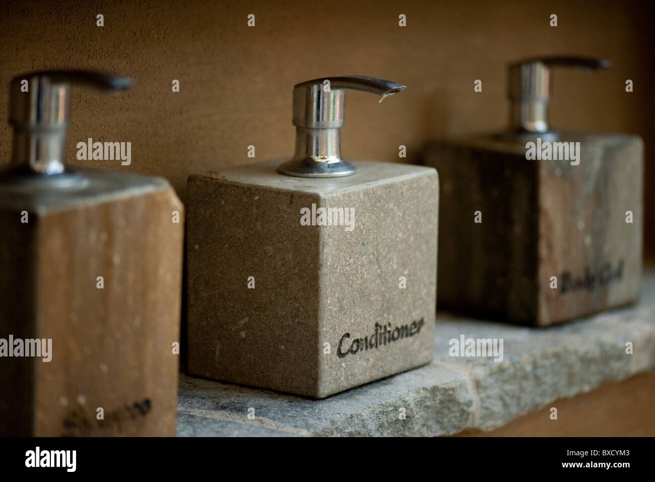Cube stone bathroom soap dispenser with a metal pump Stock Photo - Alamy