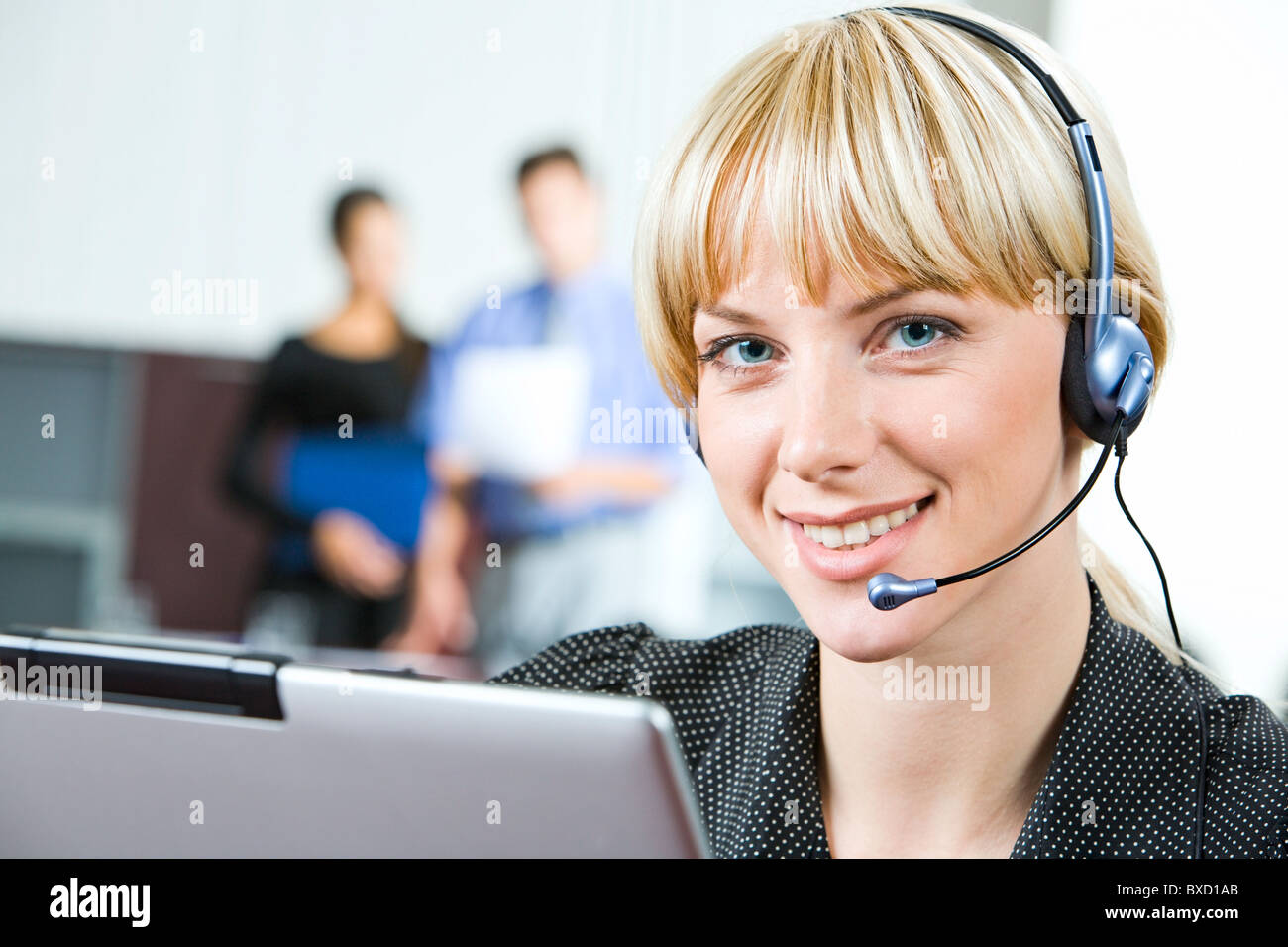 Portrait of friendly smiling telephone operator in a working ...