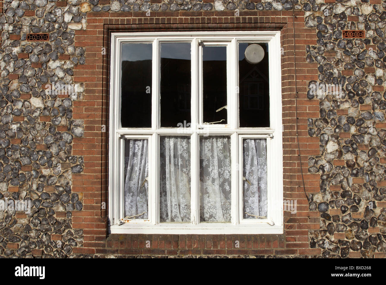 Large window on a traditional pebble-stone cladded Norfolk home United ...