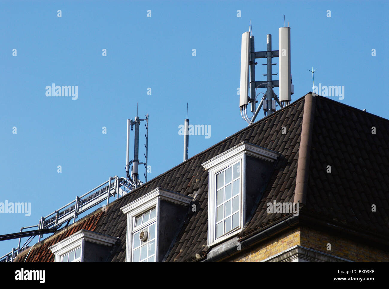 Mobile phone relays on the roof of residential housing Stock Photo - Alamy