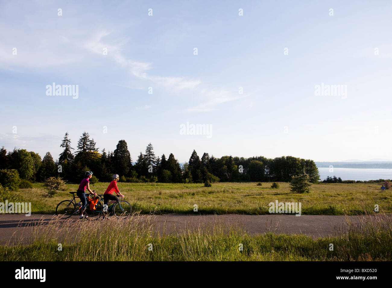 Two young women enjoy ther view on the ride home from work through a ...
