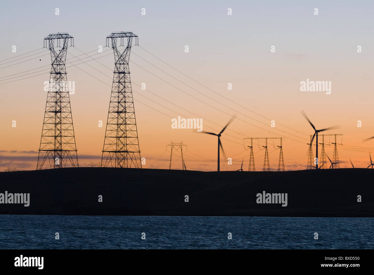 Wind turbines and power transmission lines at sunset near San Francisco ...