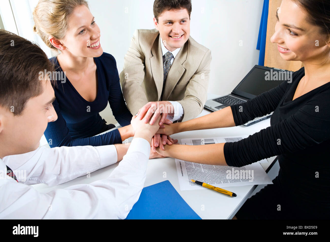 Business team putting their hands on top of each other Stock Photo - Alamy