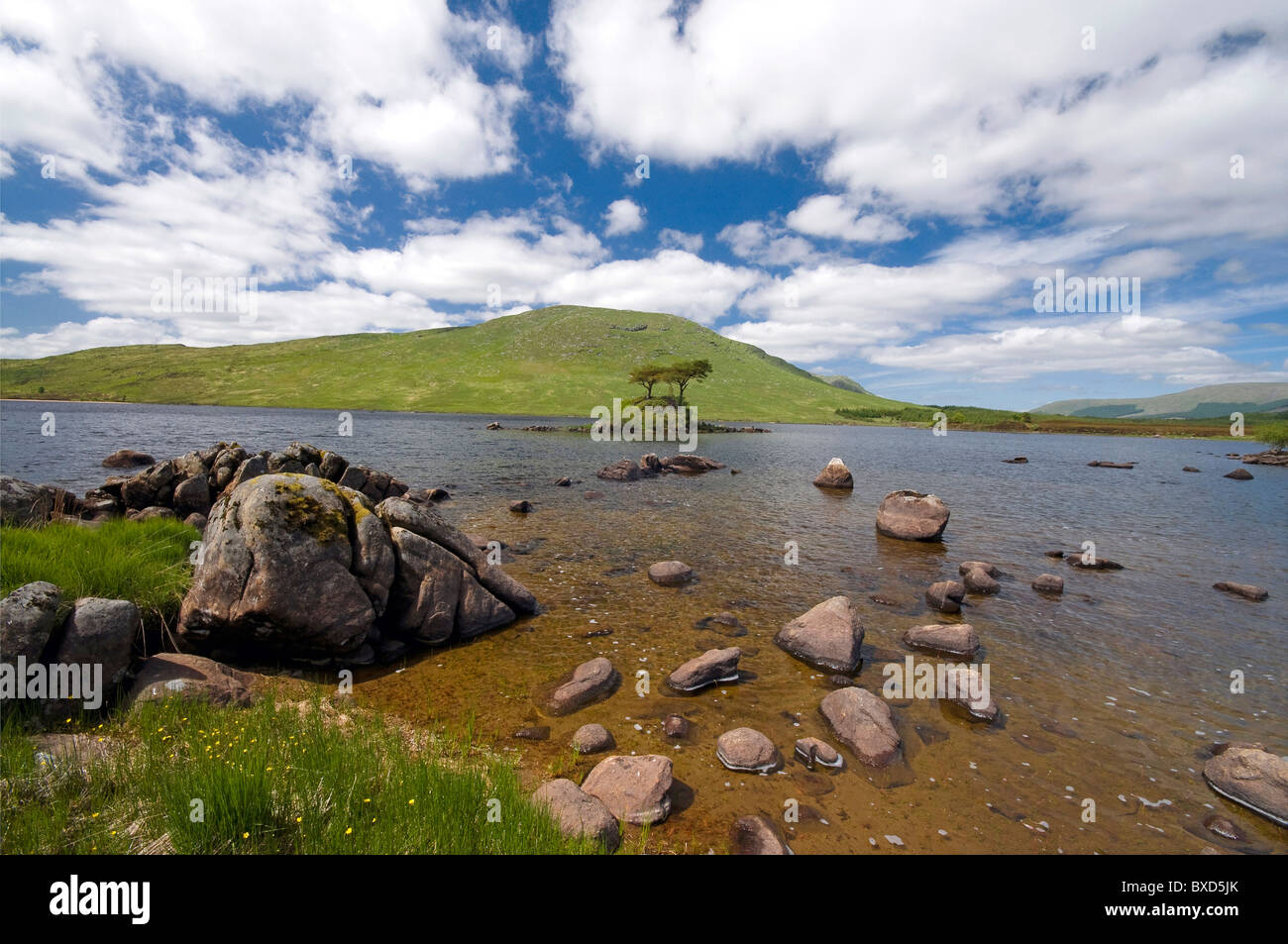 Clear water , rocks and islet on Loch Dee, Galloway Forest Park Stock ...