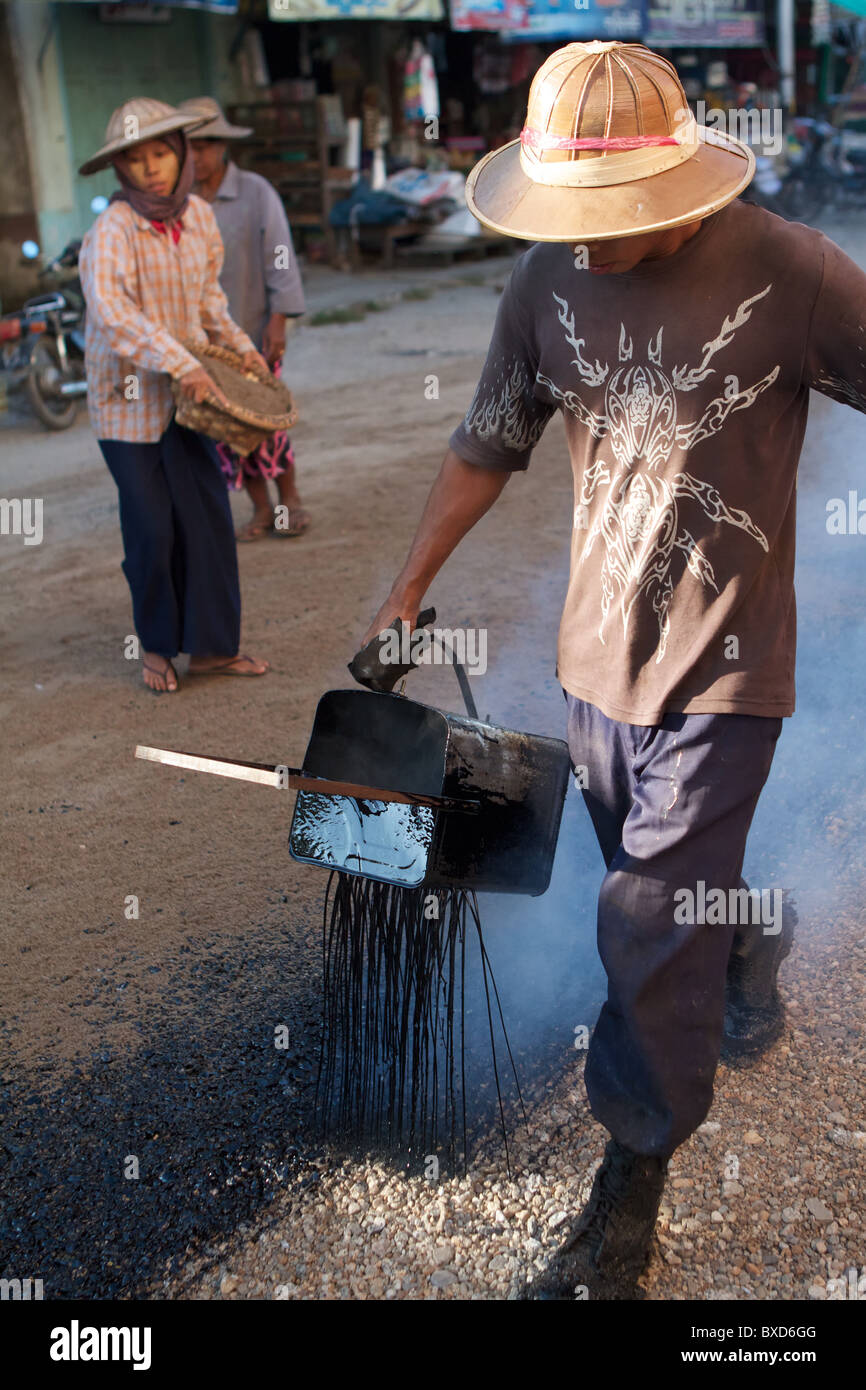 burmese man pouring tar on the road Stock Photo - Alamy