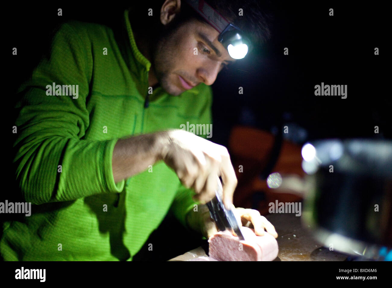 A man cuts up portions of meat for dinner in Three Rivers, California ...