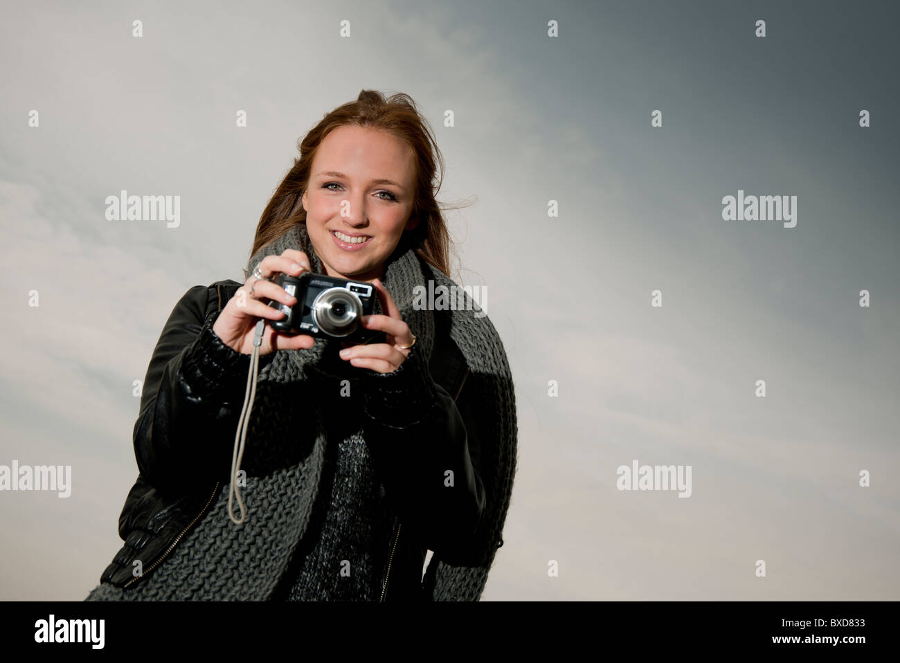 young woman taking a photo with digital camera Stock Photo - Alamy