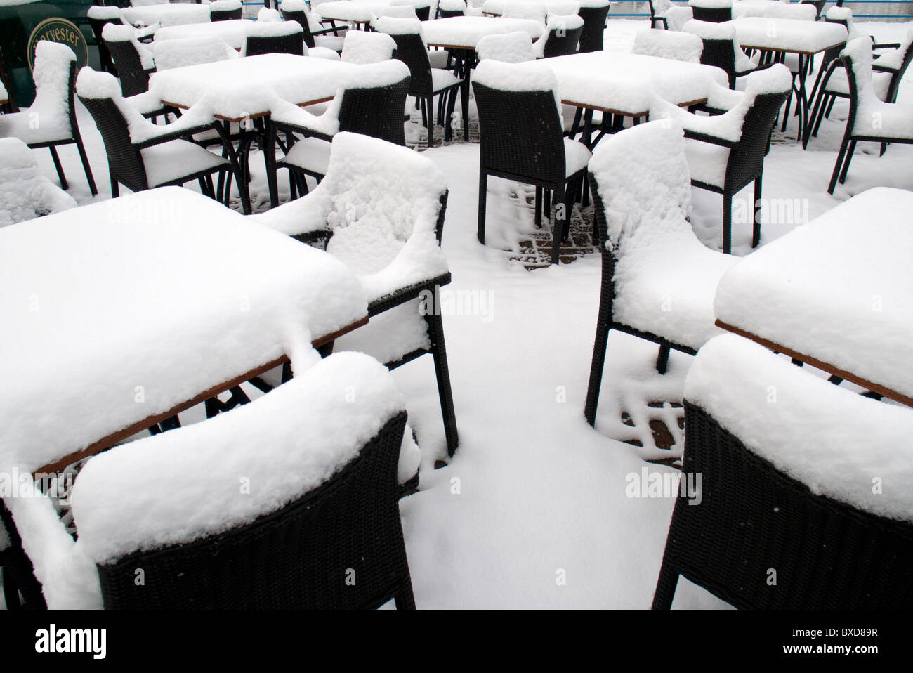 tables and chairs covered in snow Stock Photo - Alamy