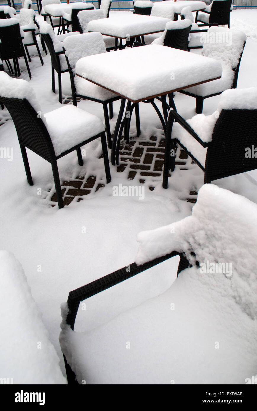 tables and chairs covered in snow Stock Photo - Alamy