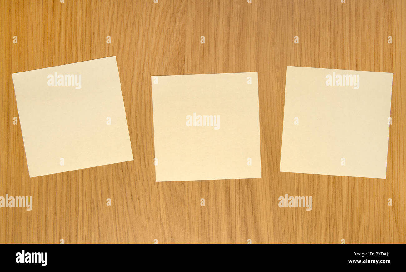 Three yellow sticky notes on wooden door Stock Photo - Alamy