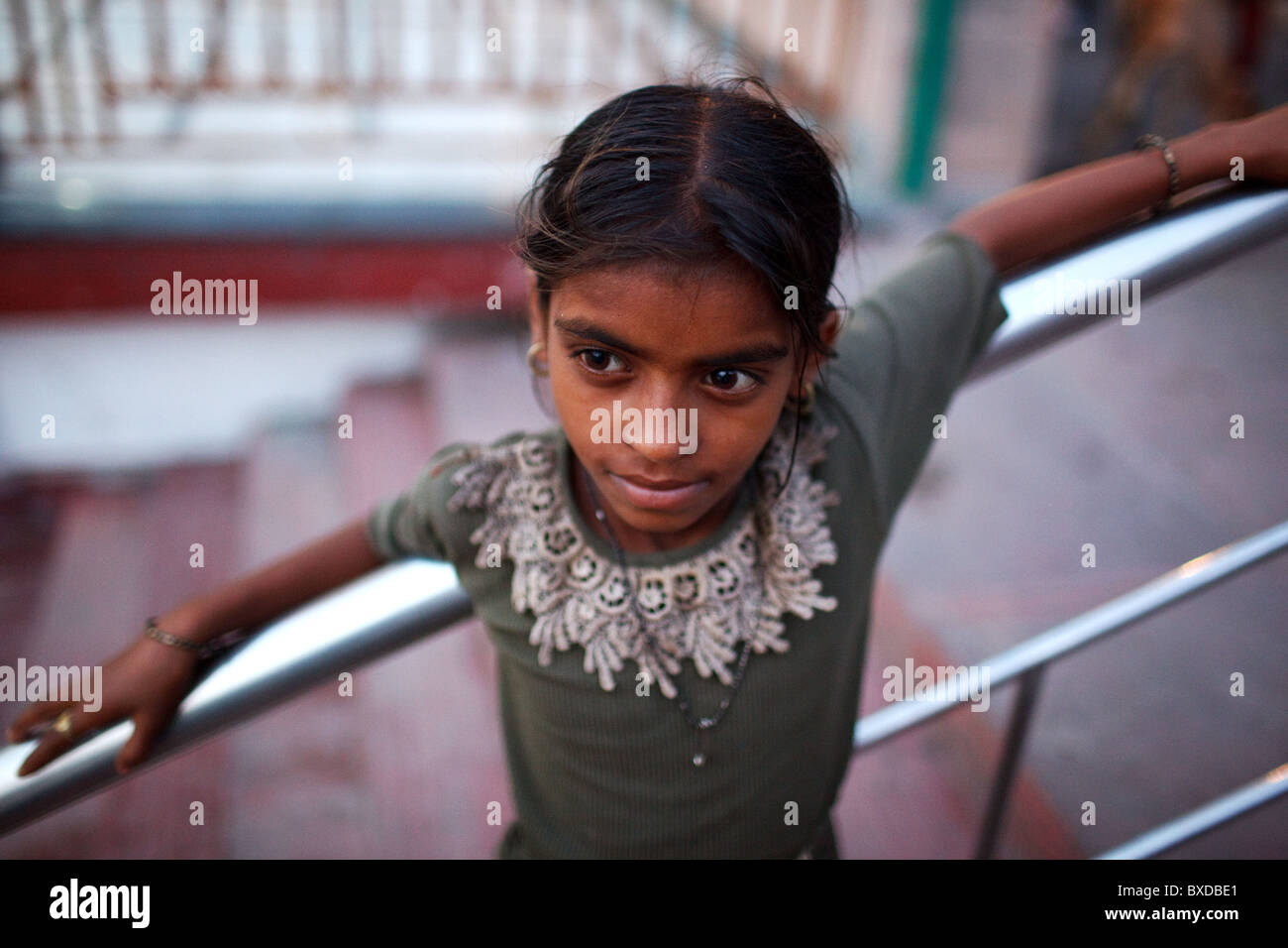 A portrait of a young Indian girl on steps to Ganges in Rishikesh ...