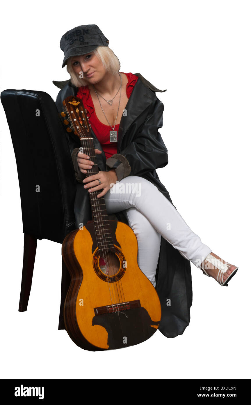 A young woman is sitting on a chair with her guitar Stock Photo - Alamy