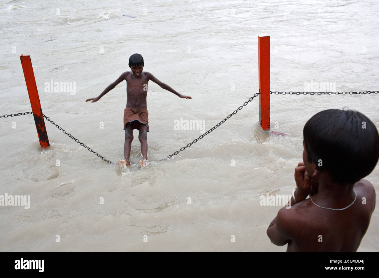 Two boys playing in the water in the Ganges river in Haridwar ...