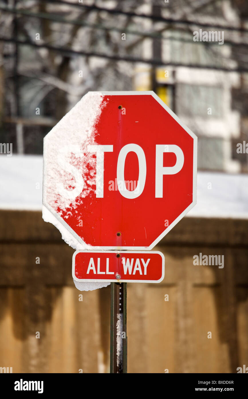 Stop sign partially covered with snow Stock Photo - Alamy