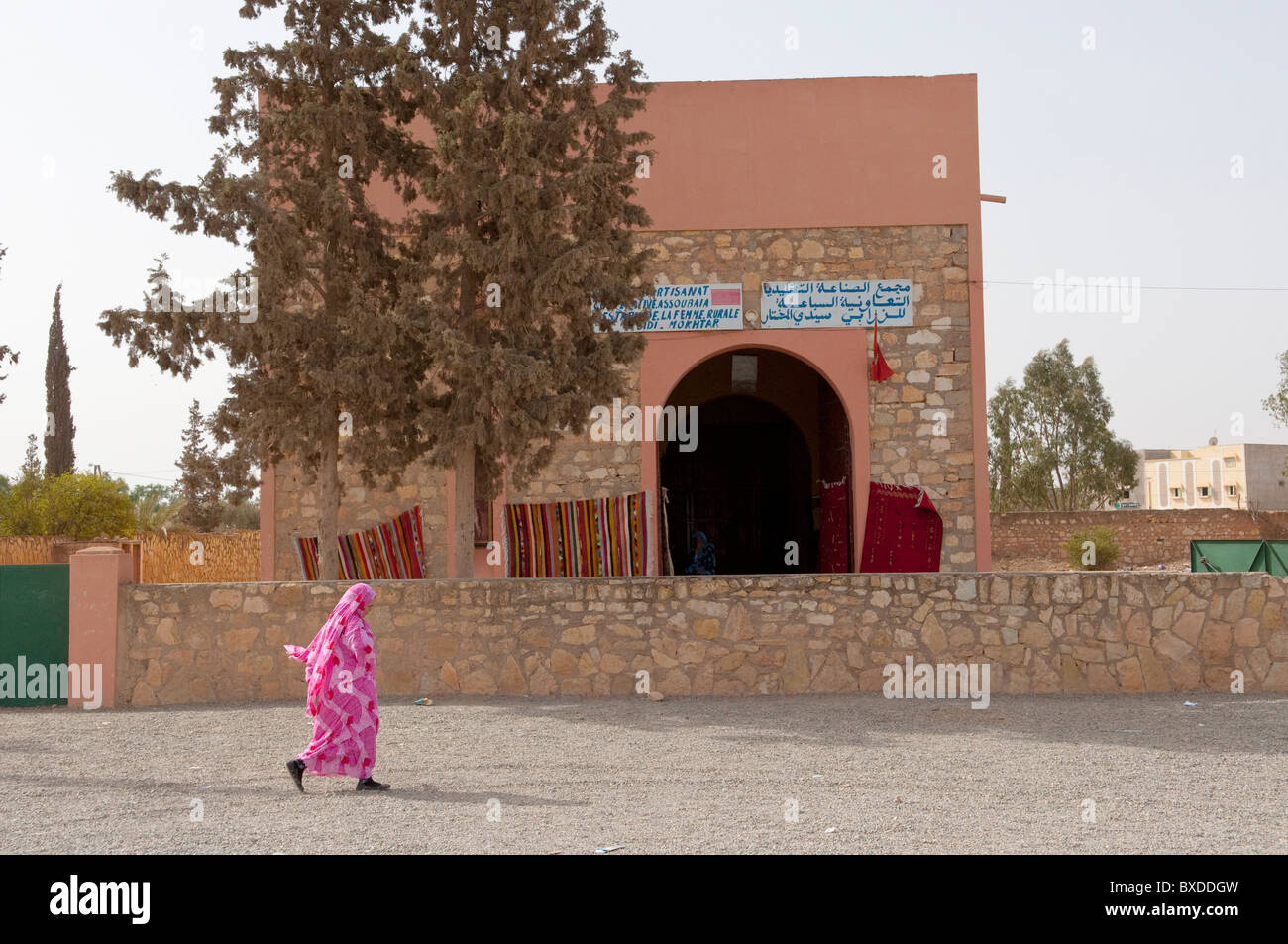 A Muslim lady in ethnic dress walking along a street in a Western ...