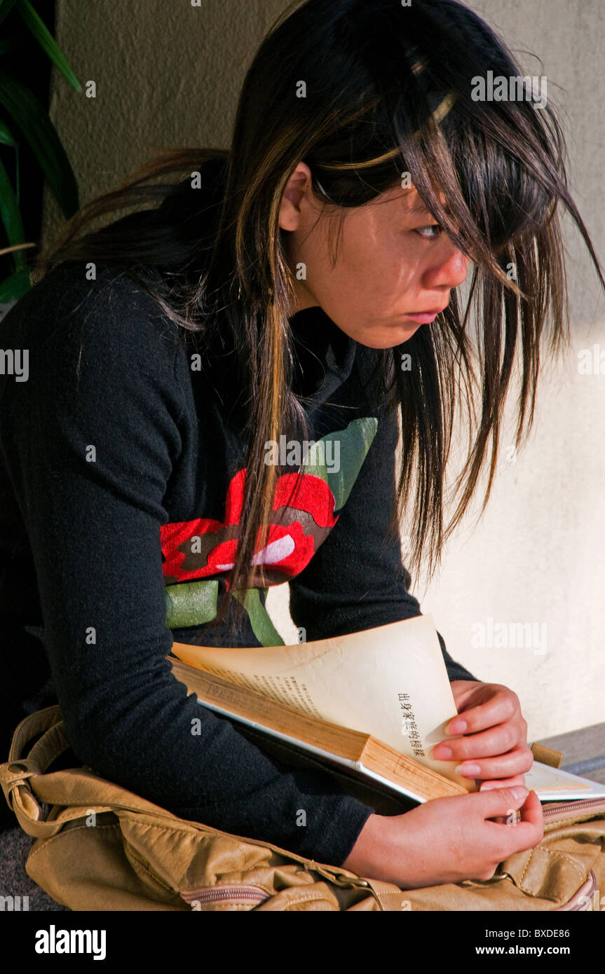 Pretty young Asian girl studying Stock Photo - Alamy