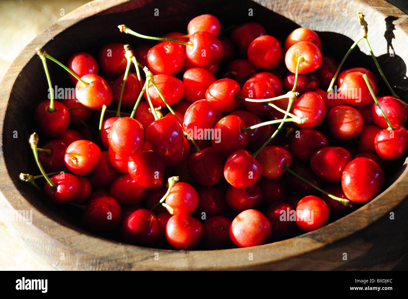 red cherries in brown wooden bowl Stock Photo - Alamy
