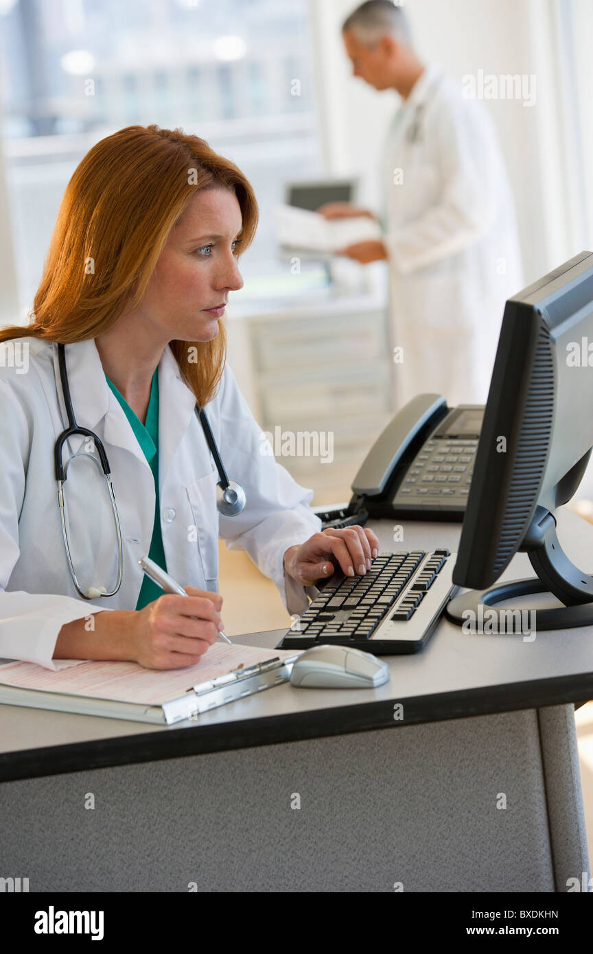 Doctor working on computer Stock Photo - Alamy