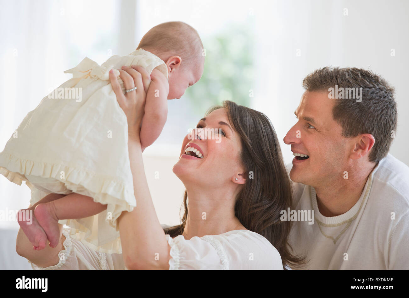 Proud parents and their baby daughter Stock Photo - Alamy