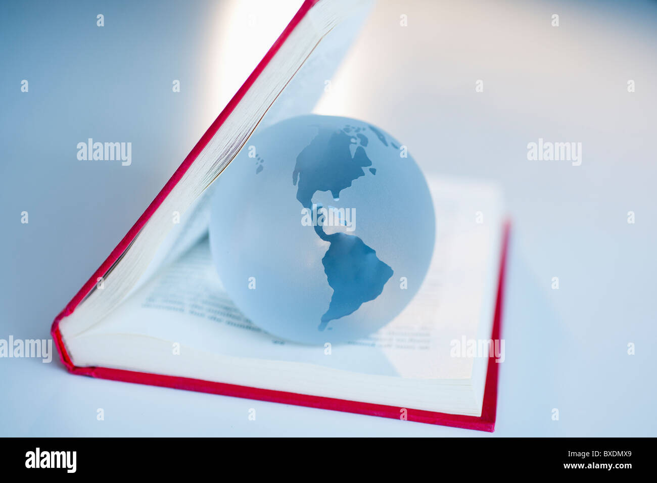 Globe inside a book Stock Photo - Alamy