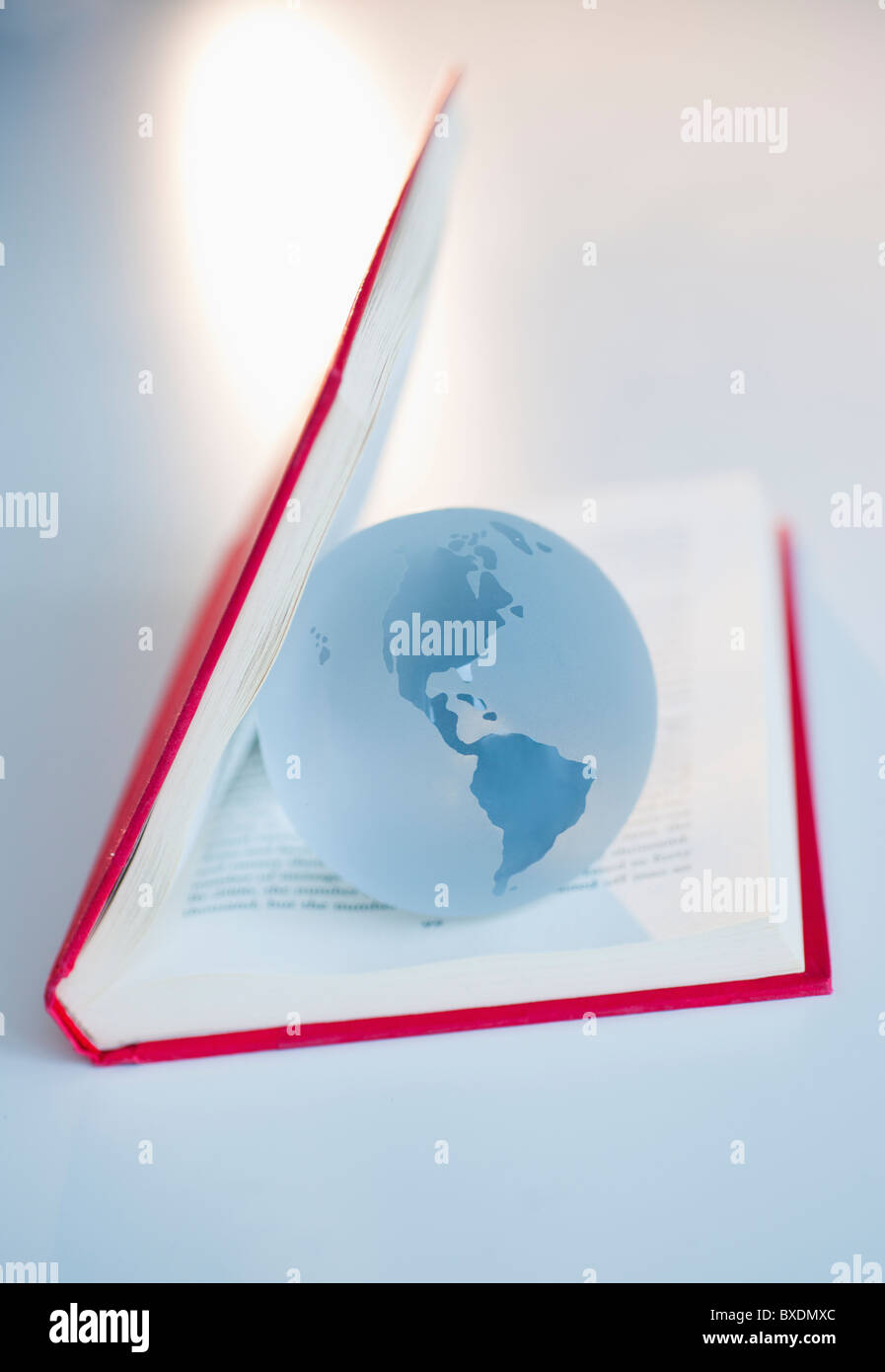 Globe inside a book Stock Photo - Alamy